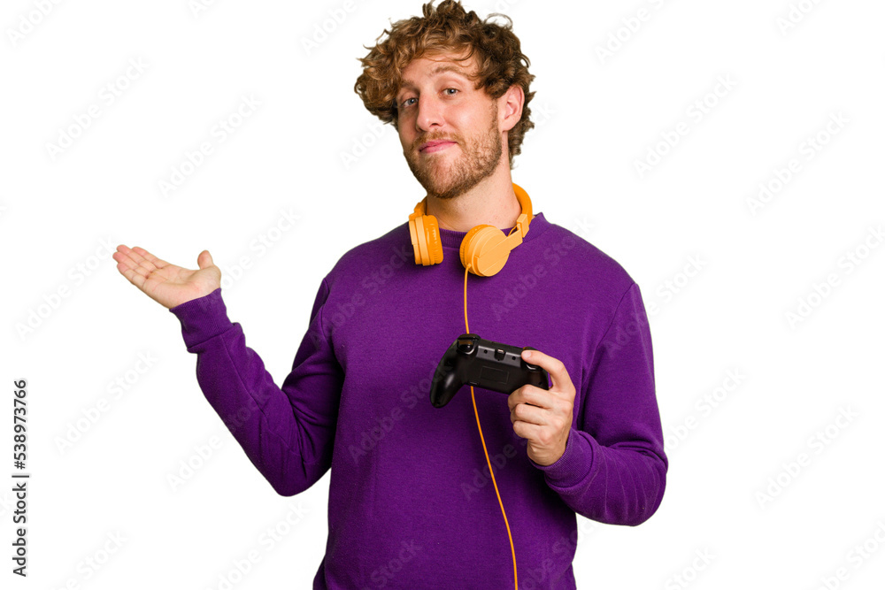 Young caucasian gamer man holding a game controller isolated on white ...