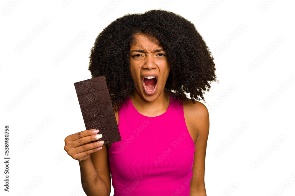 Young African American woman holding a chocolate bar isolated screaming ...