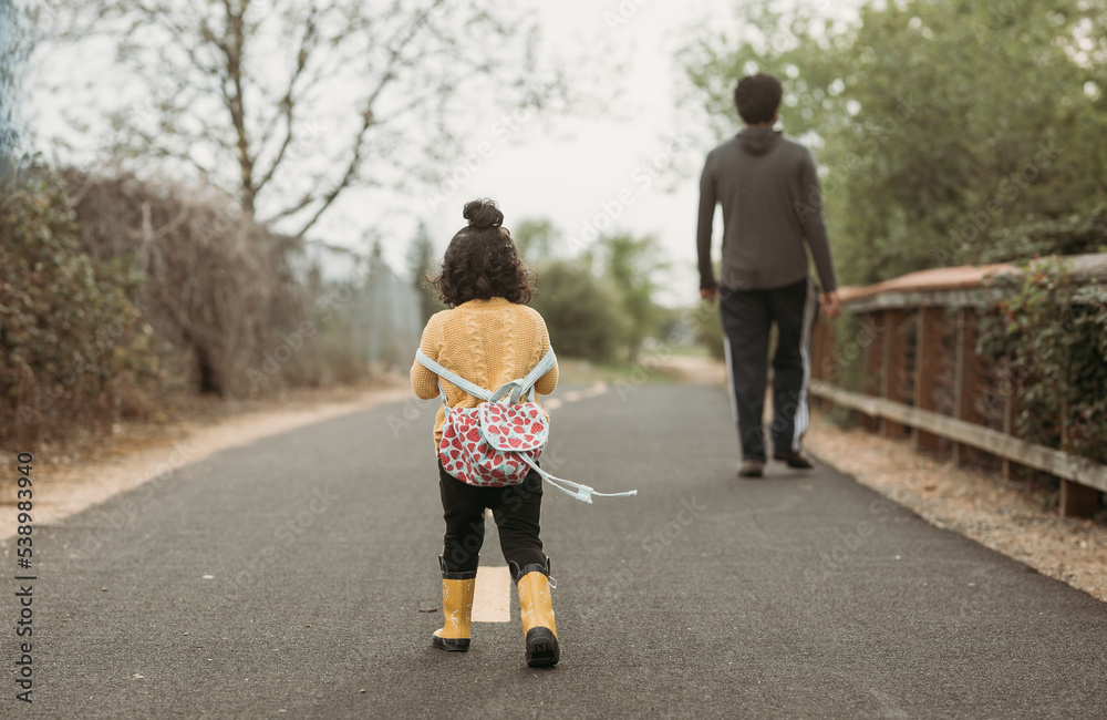 Little girl walking towards her Dad outdoors at a park Stock Photo ...
