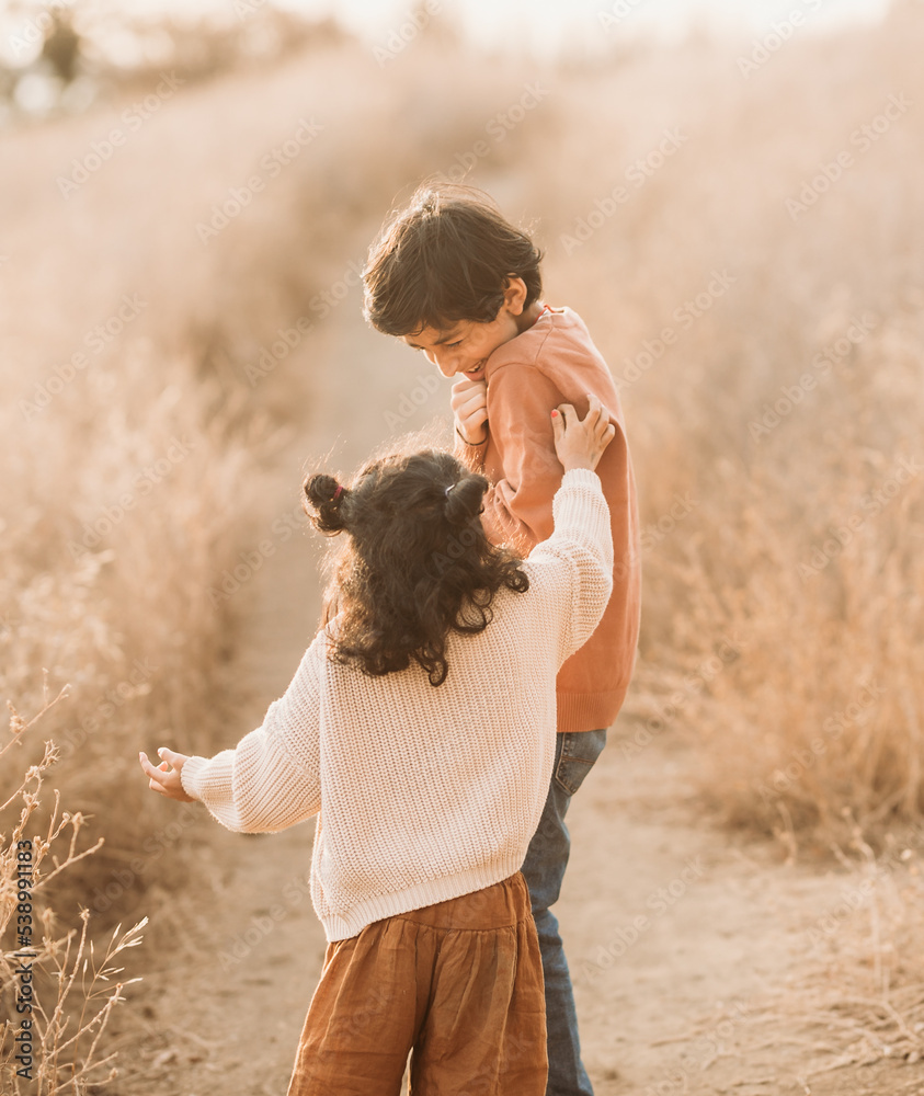 Little kid tickling her brother having fun Stock Photo | Adobe Stock