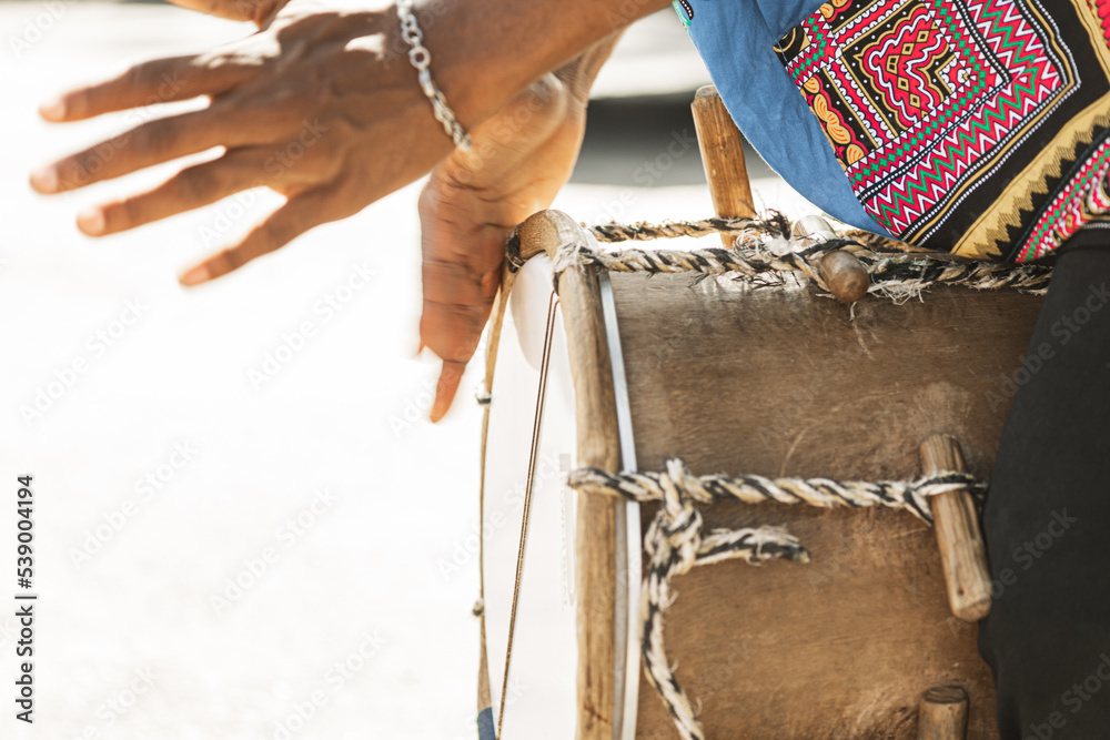 Poster A person playing a traditional instrument of the Garifuna ...