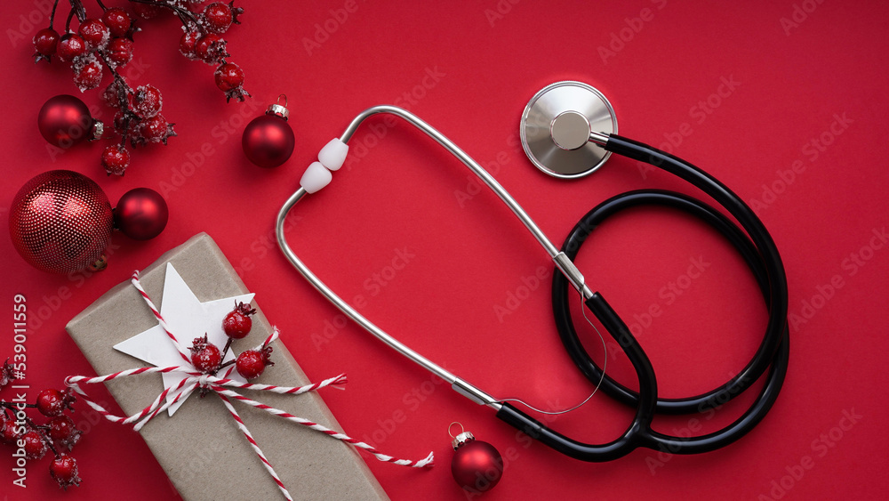 Christmas medical banner. Close up gift box, berries, red balloons and ...