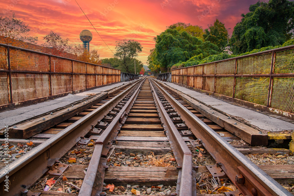 as long set of rusty iron and wood railroad tracks surrounded by the ...