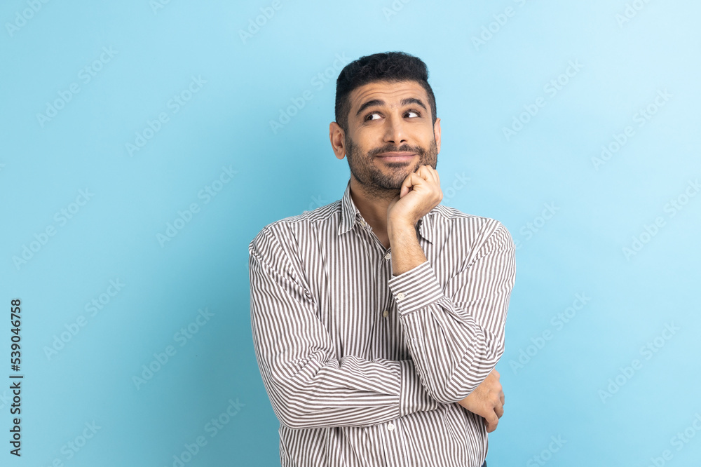 Poster Businessman standing and looking away with thoughtful expression ...