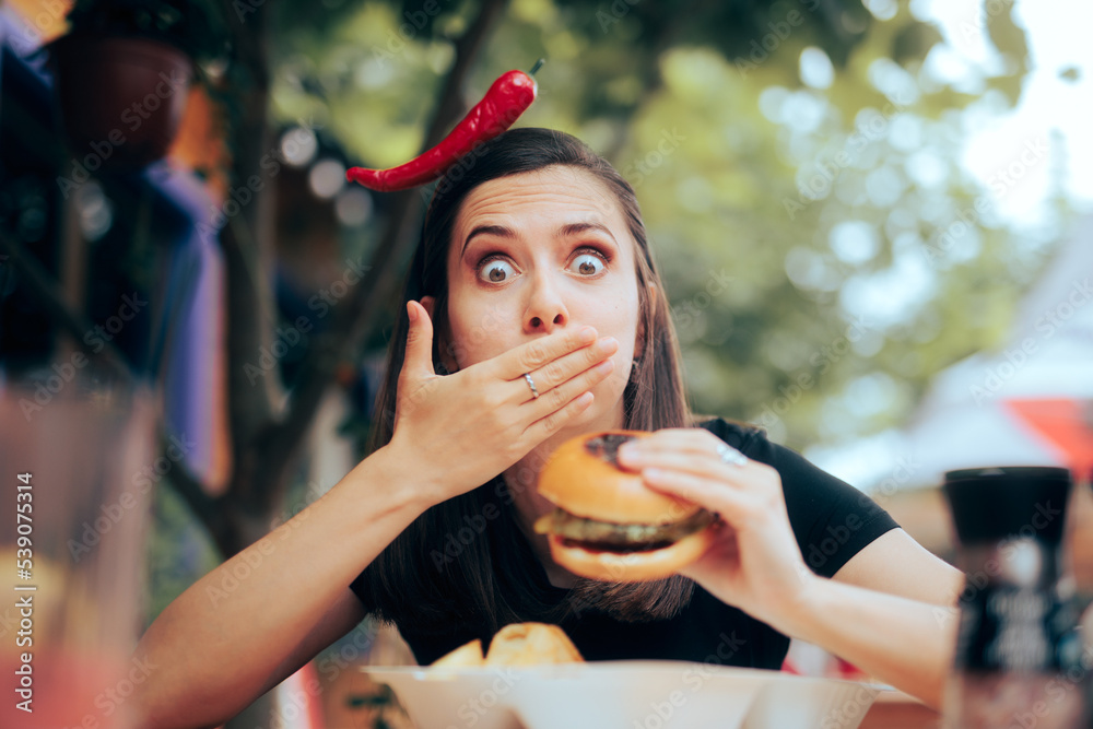Funny Woman Trying a Spicey Burger in Restaurant. Sick person having a ...