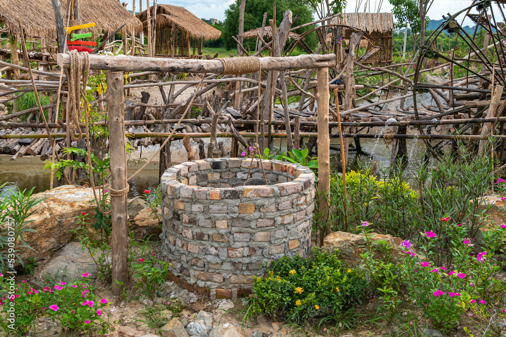 Beautiful artesian well made by bricks with cement and wheel pulley ...