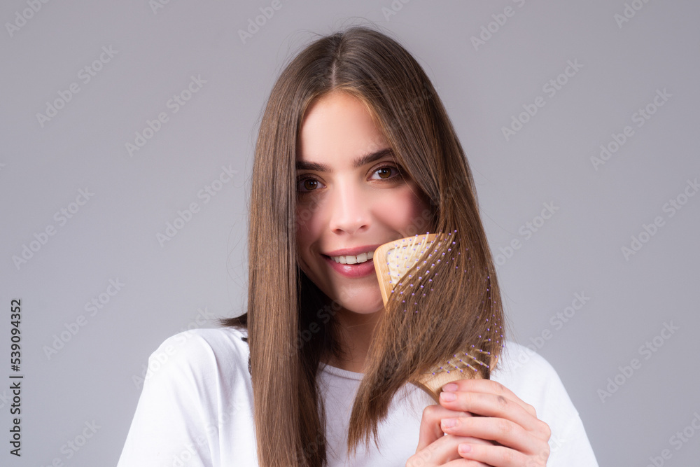 Beautiful woman combs her healthy hair. Combing healthy long straight ...