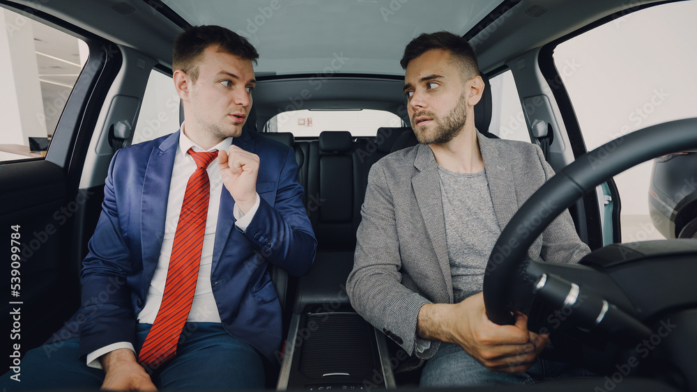 Young confident businessman is discussing new car with professional ...