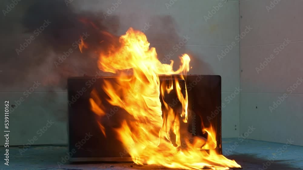 microwave oven on fire. the concept of fire in the kitchen and ...