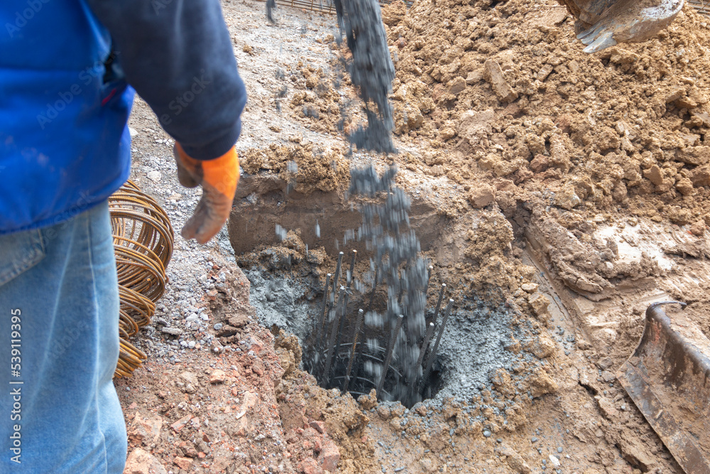 Concreting the foundation piles for the new construction site ...