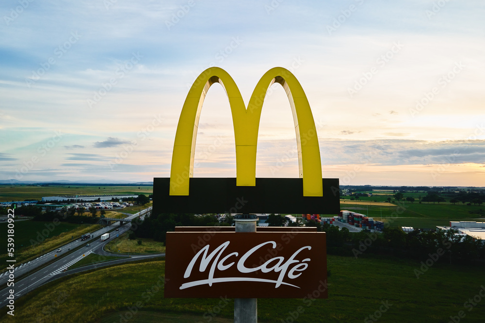 McDonalds logo with McCafe sign near highway, aerial view. McDonald's ...
