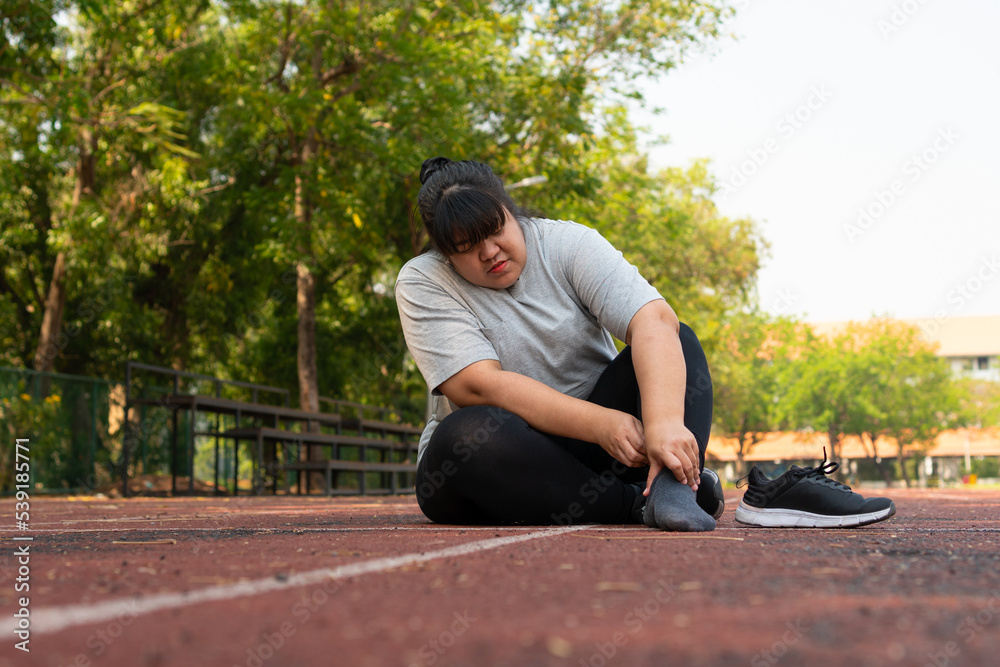 Asian overweight woman a new runner pain ankle during running, Athlete ...