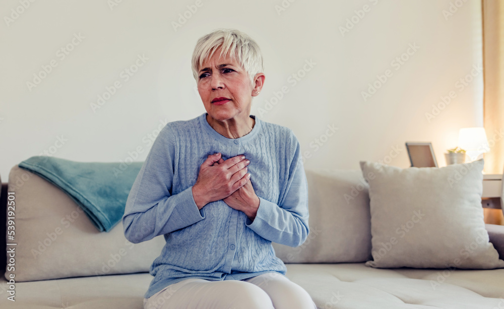 Pressure in the chest. Close-up photo of a stressed woman who is ...