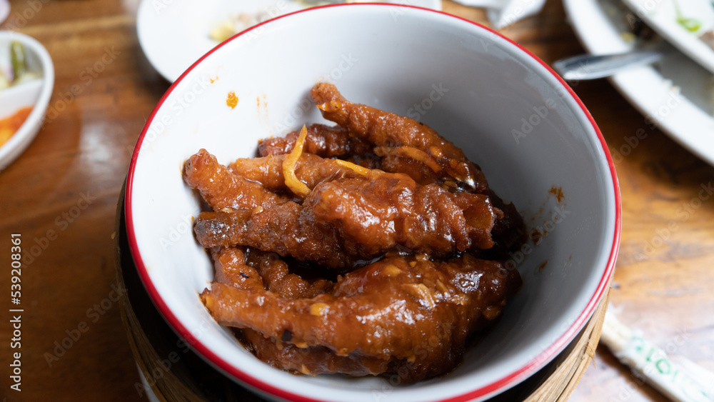 angsio or chicken feet cooked with a spicy red sauce that taste savoury ...