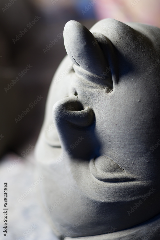 face of goddess kali idol being sculpted with clay during kali puja or ...