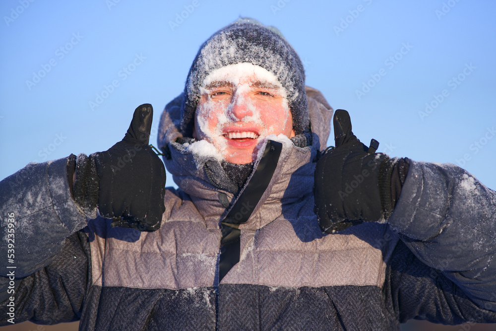 portrait of face of happy guy covered in snow, young positive man frost ...
