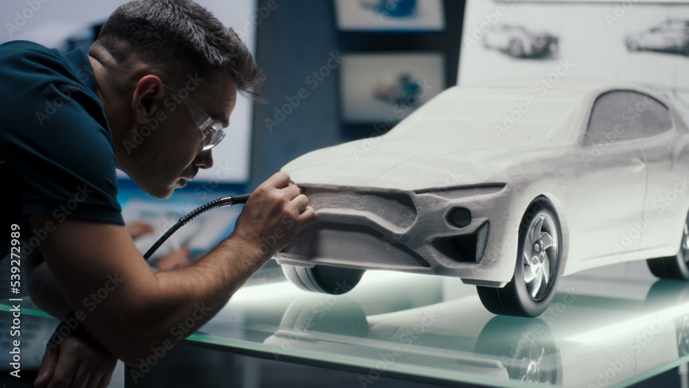 Automotive engineer makes the design corrections to a prototype car ...