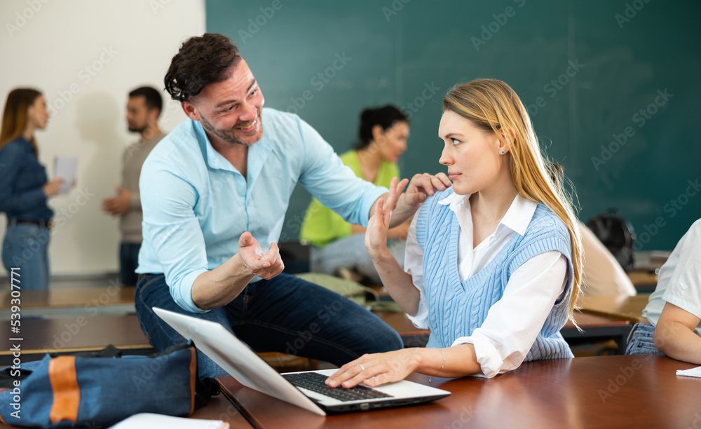 Dissatisfied female student showing stop gesture to annoying male ...