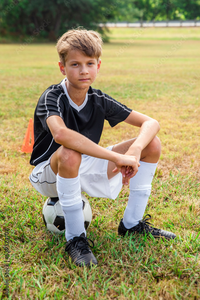 Child Youth Boy Siting on Soccer Ball on Soccer Field Stock Photo ...