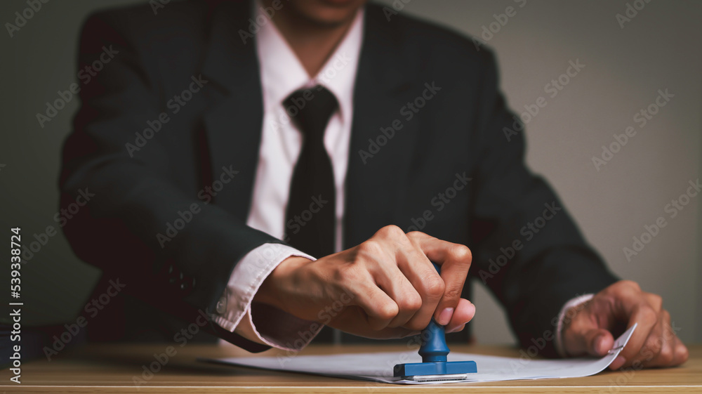 Businessman person with a stamp of approval on a public notarization ...