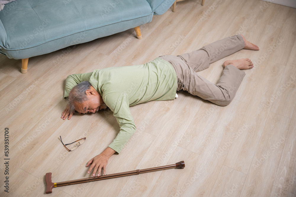 Sick senior old man falling down lying on floor because stumbled at ...