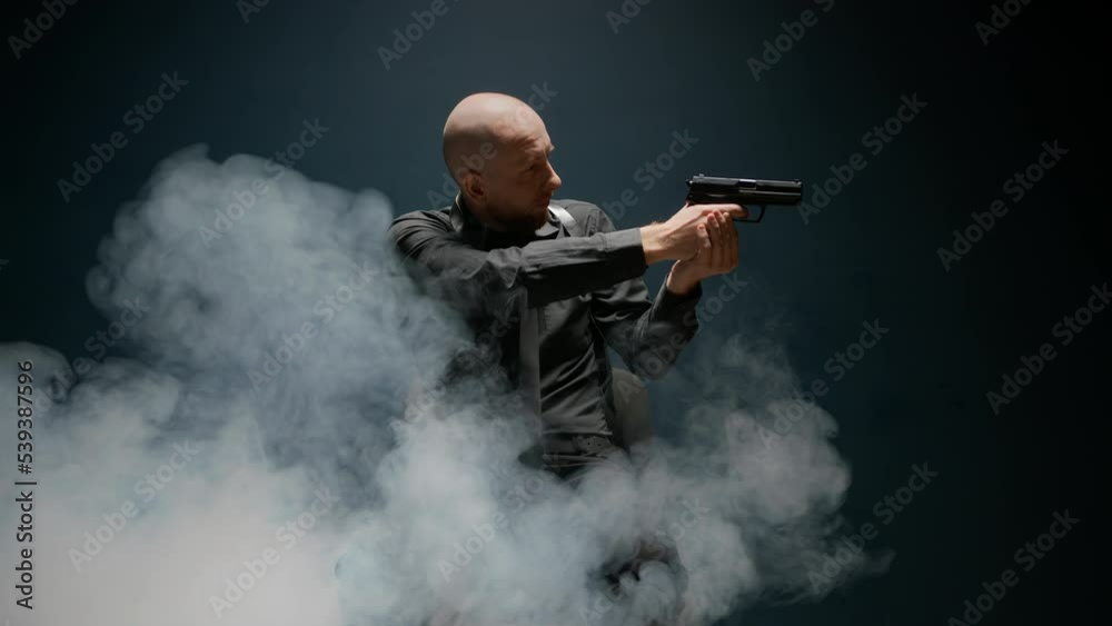 Police detective holds service pistol gun in his hand and aims at the ...