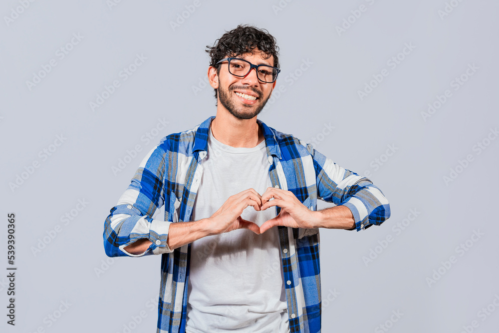 Teenage guy making heart shape with hands isolated. Happy man making ...