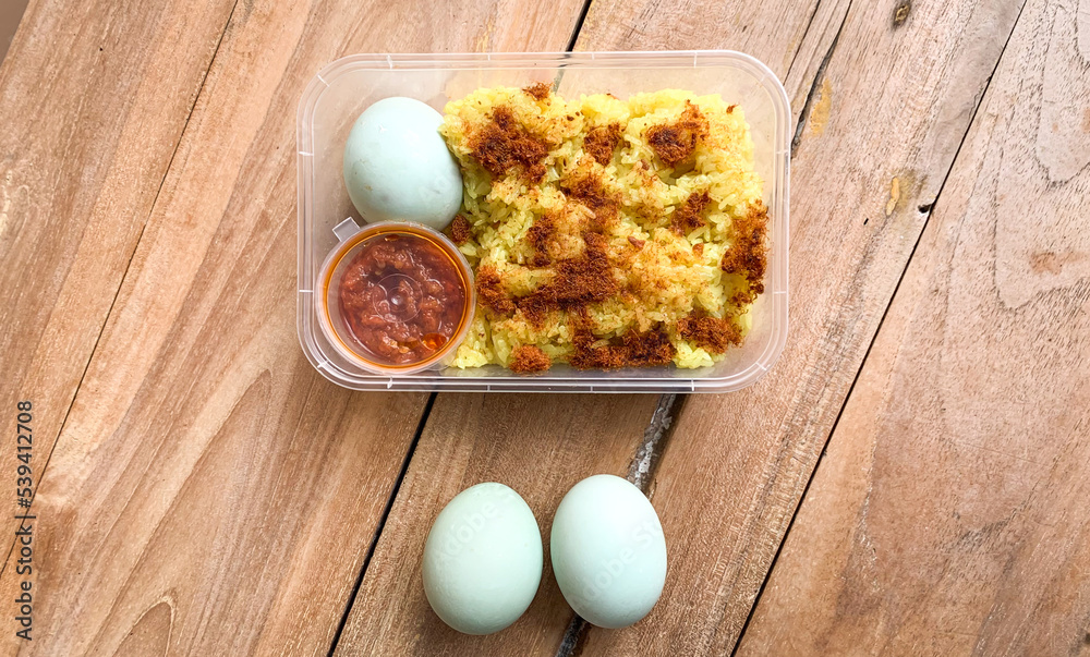 Yellow sticky rice with fish floss, sambal and salted egg as side dish ...