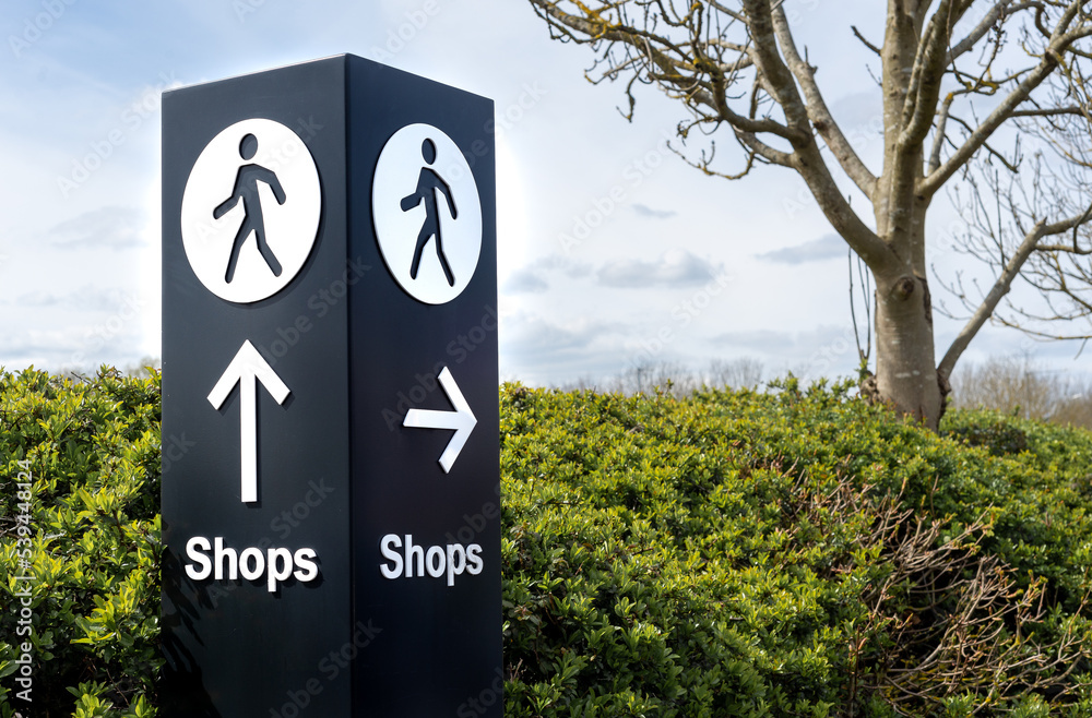 Poster Large black and white free standing directional sign with person ...