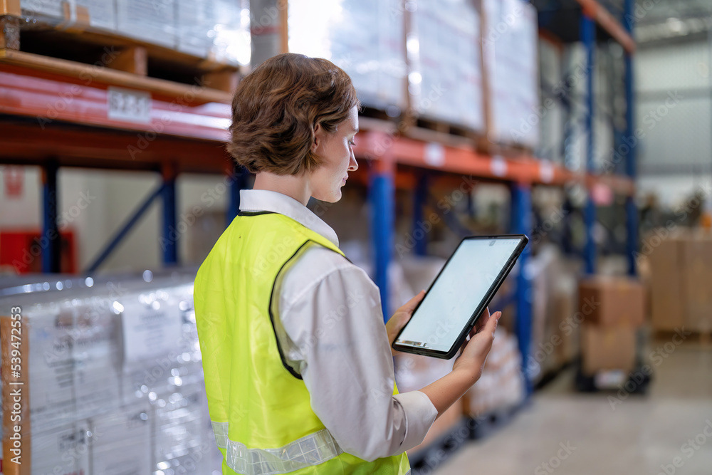 Worker in warehouse hold tablet check list perform inventory stock ...