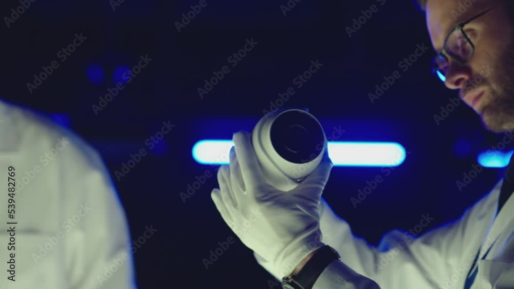 Professional scientists in white coats working inside modern futuristic ...
