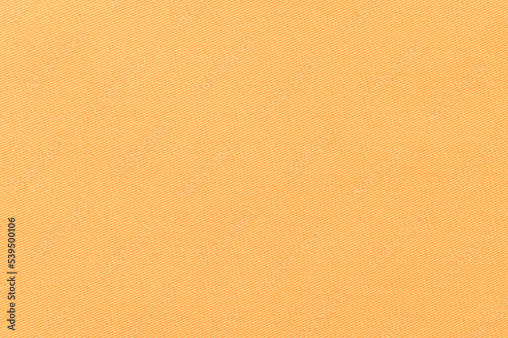 Texture of natural orange color twill fabric close-up. the background ...