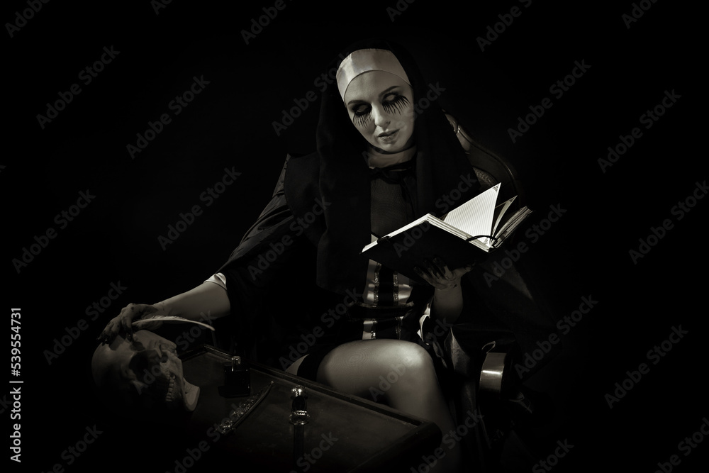An evil cursed nun with a notebook and a cross in her hands looks at ...