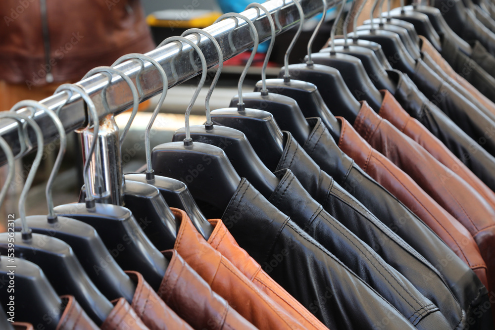 leather jackets hung on hangers in the worked leather clothing store ...