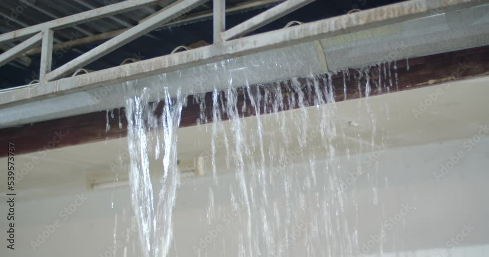 A heavy rain storm caused the gutter to overflow and cause water to ...