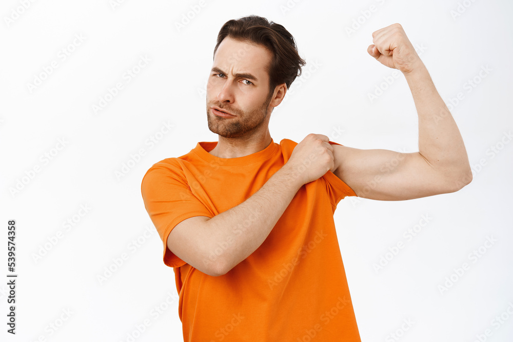 Sport And Gym Concept Happy Guy Flexing Biceps Shows His Strong