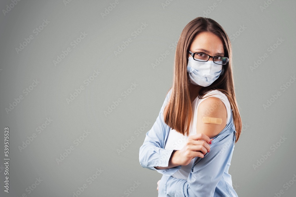Happy adult woman shows her arm that just received the Covid-19 vaccine ...
