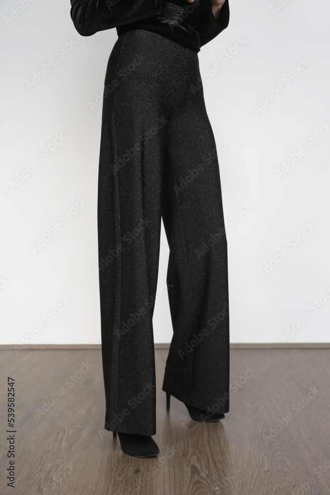 Serie of studio photos of female model wearing wide black elegant ...