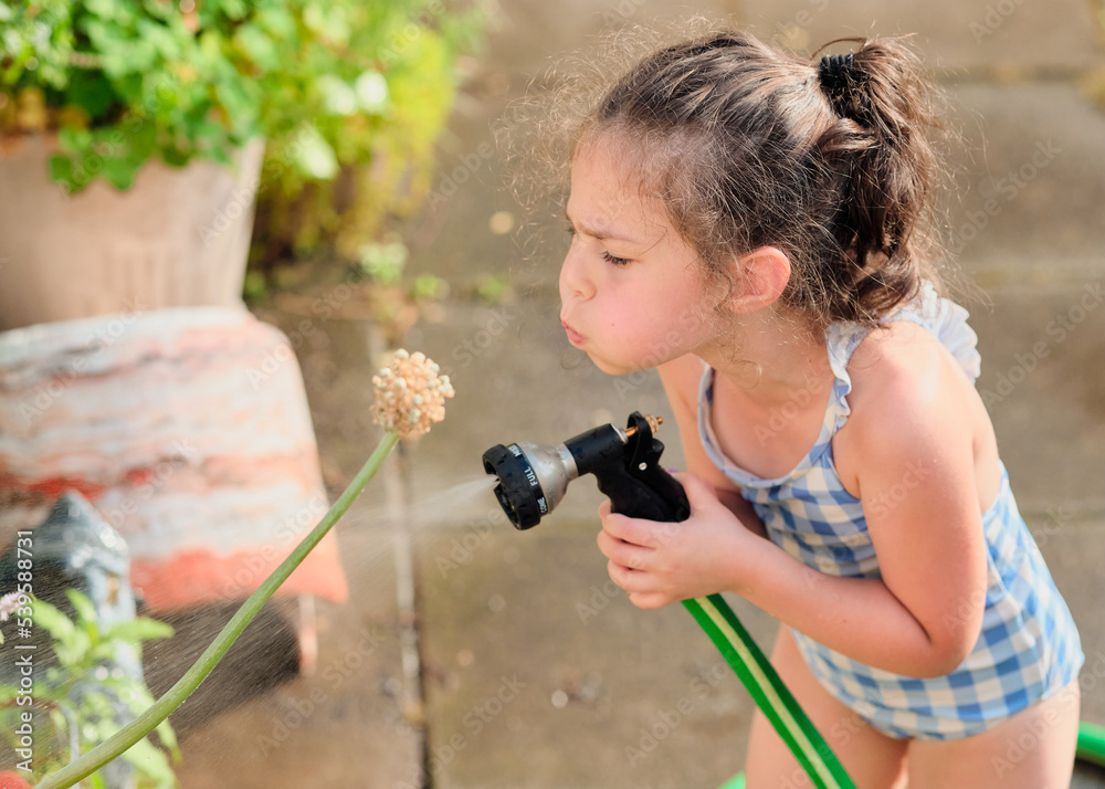 Beautiful Girl In A Bathing Suit Is Watering Plants On A Summer Day 3711