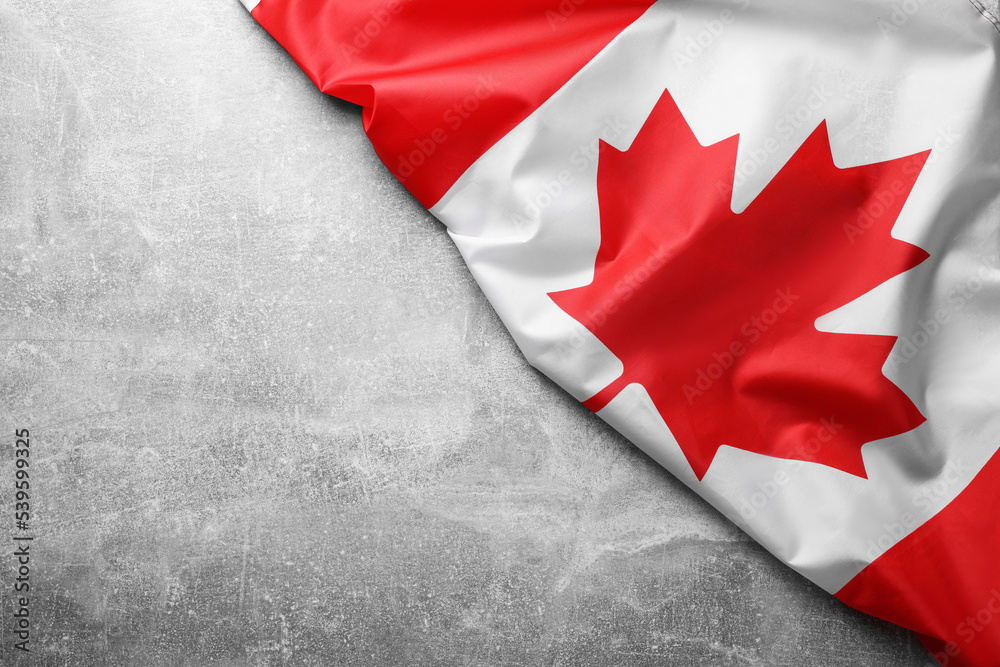 Flag of Canada on light grey stone table, top view. Space for text ...