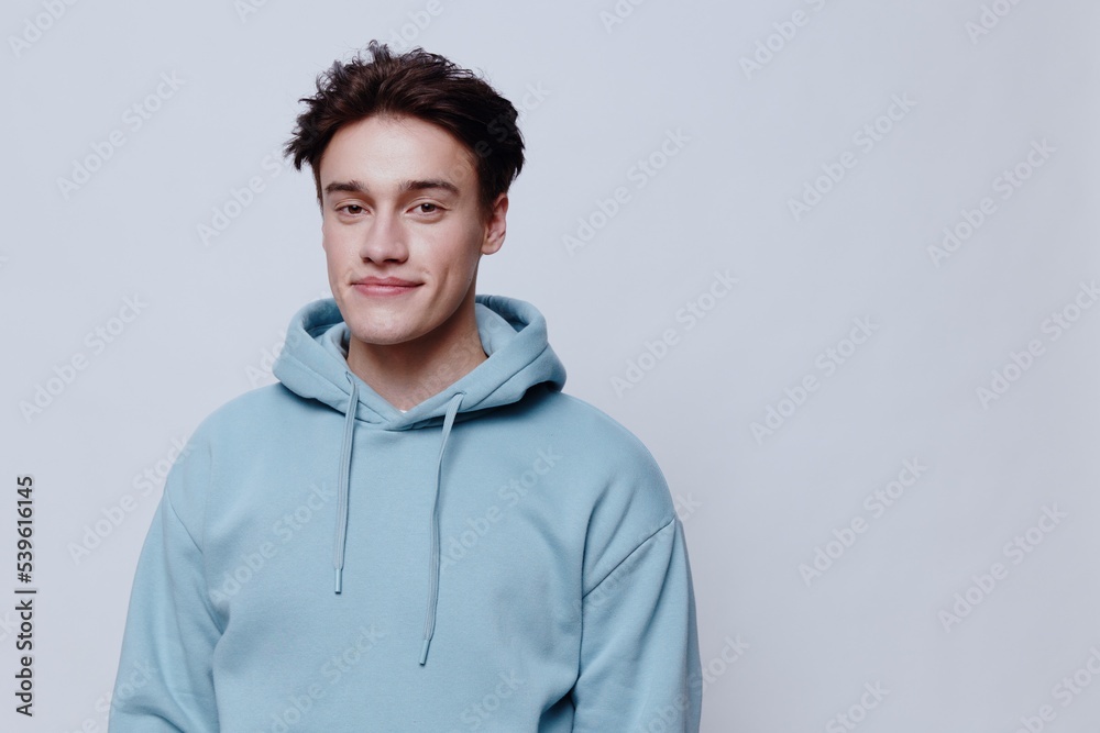 horizontal portrait photo .a nicely smiling young man in a light light ...