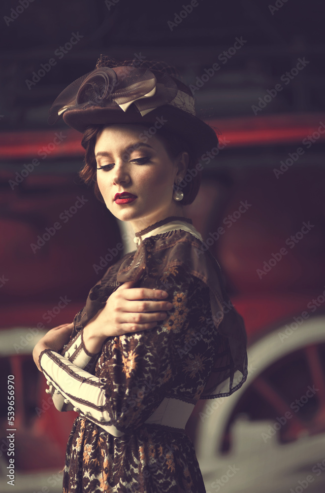 Beautiful girl in a historical retro dress on a background of an old ...