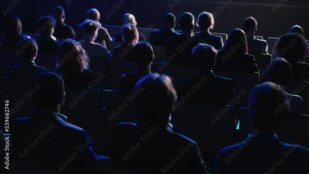 Audience Full of Tech People in Dark Conference Hall Watching an ...