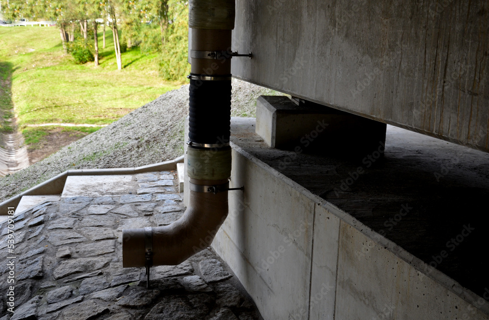 freeway bridge drainage. A sound-absorbing wall with holes lets water ...