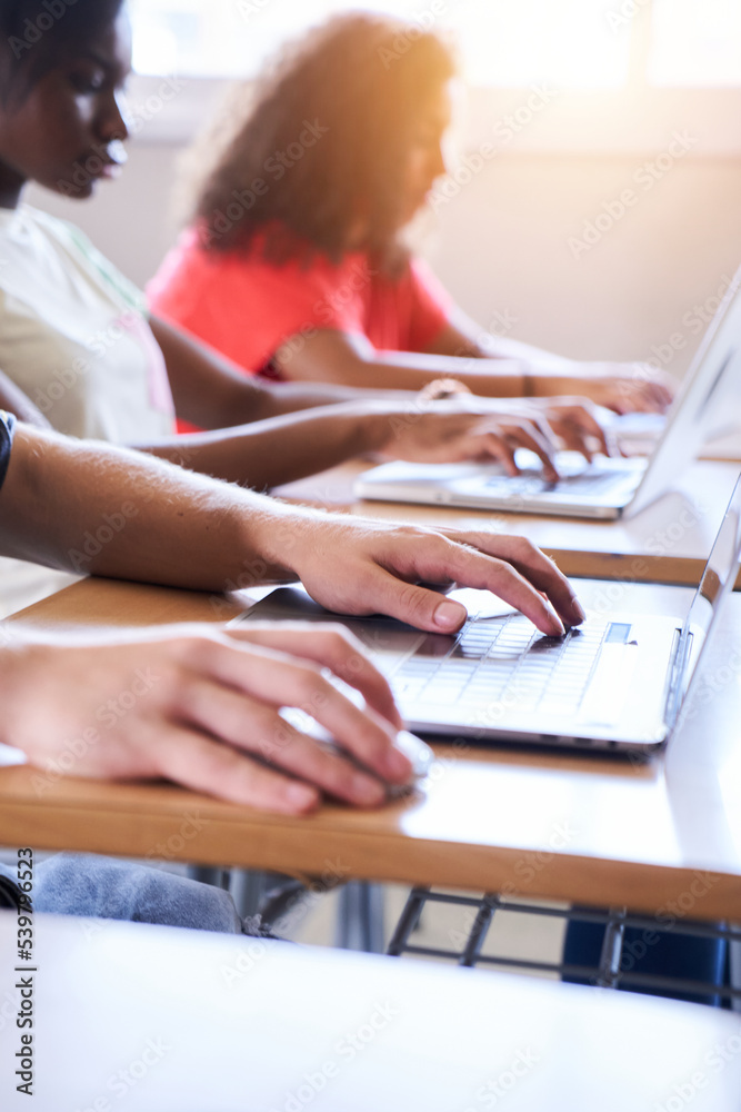 Vertical Close-up of the laptop in the classroom. A multi-ethnic group ...