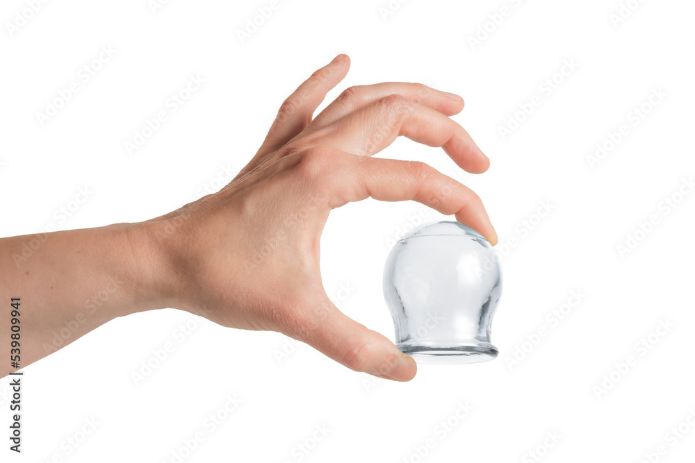 A hand holds a cupping therapy cap with index finger and thumb ...