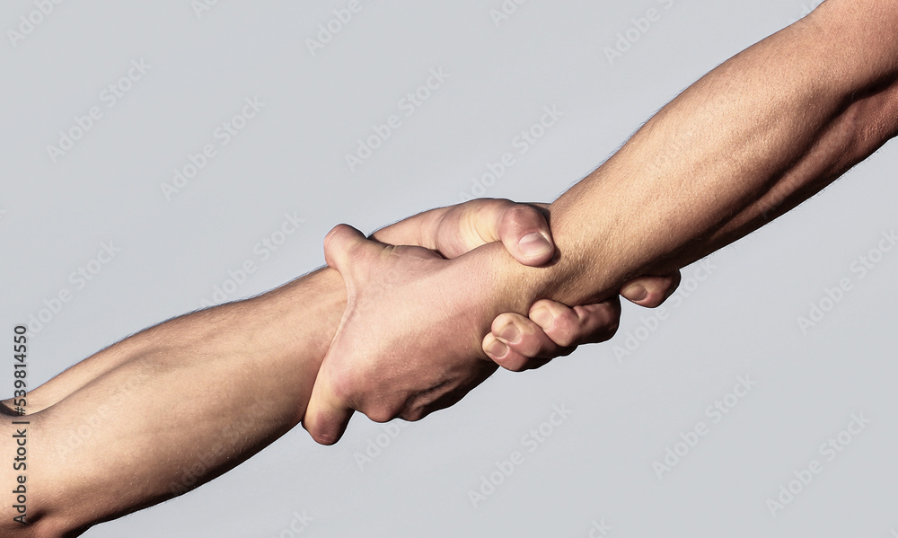 Helping hand concept, support. A friendly handshake. Two hands, shaking hands. Rescue, helping ...