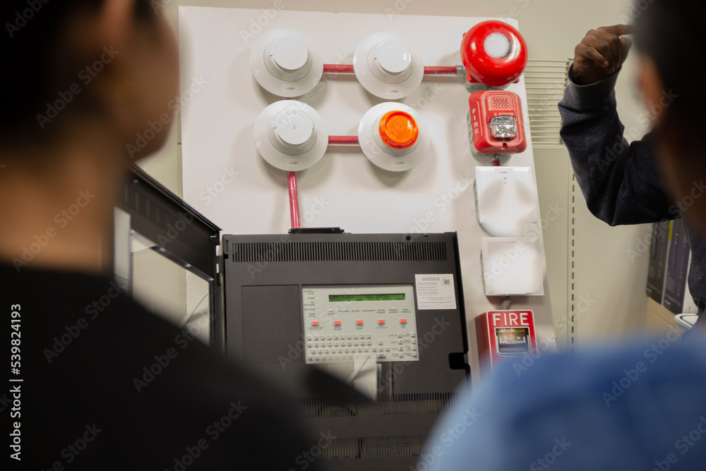 Pull station fire alarm system and mock sprinklers attached to a white ...