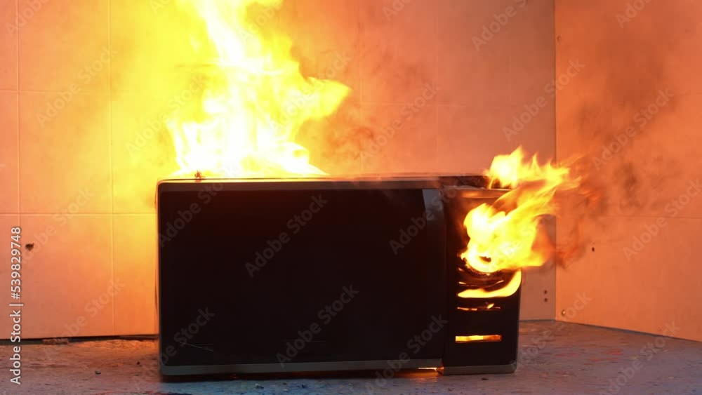 microwave oven on fire. the concept of fire in the kitchen and ...
