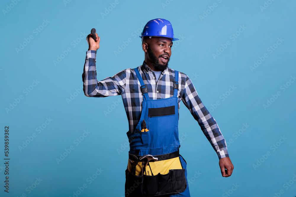 African american construction worker wearing coverall and tool belt ...